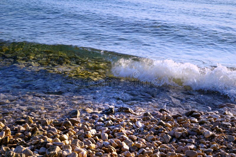 Pebble Sea Shore Splashed by Crystal Clear Sea Waves Stock Photo ...