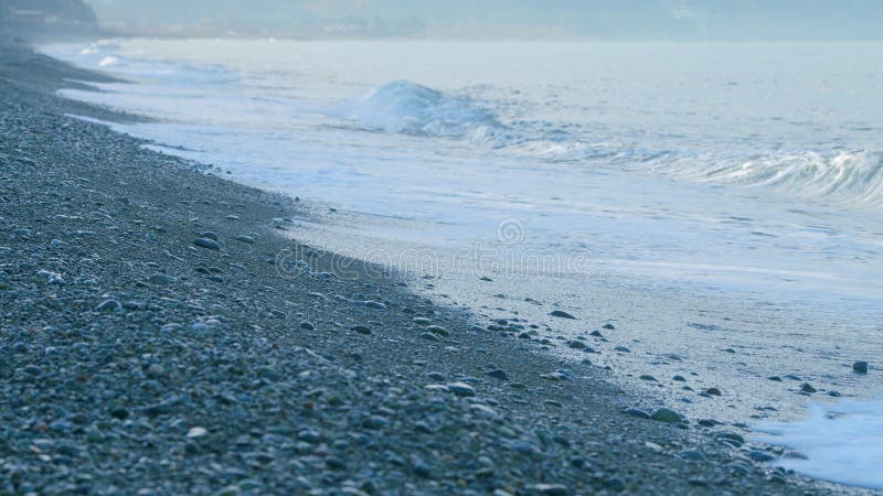 Pebble Stone Beach on Sunset. Foamy Water Waves Crashing on Pebble ...