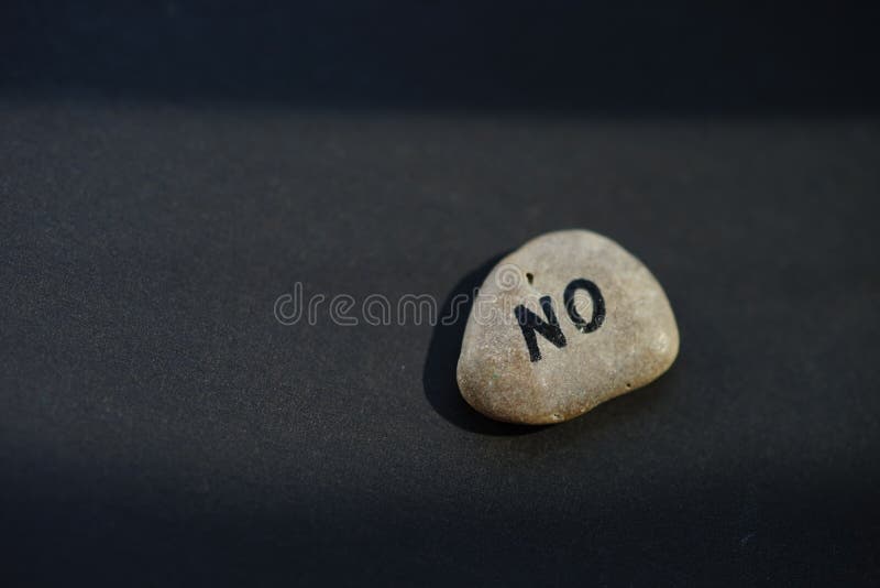 Pebble Stone with Text NO on Black Table Stock Photo - Image of black ...