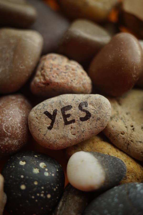 Pebble Stone with the Text Yes in a Heap of Empty Pebbles Stock Photo ...
