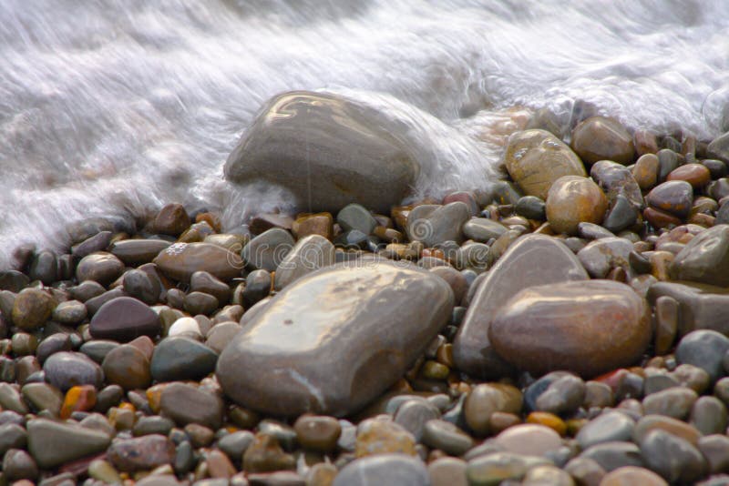 Stones in a Wave stock image. Image of superior, stone - 61283109