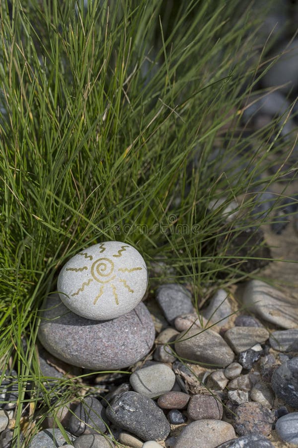 Pebble with sun symbol stock photo. Image of stone, outdoor - 127309272
