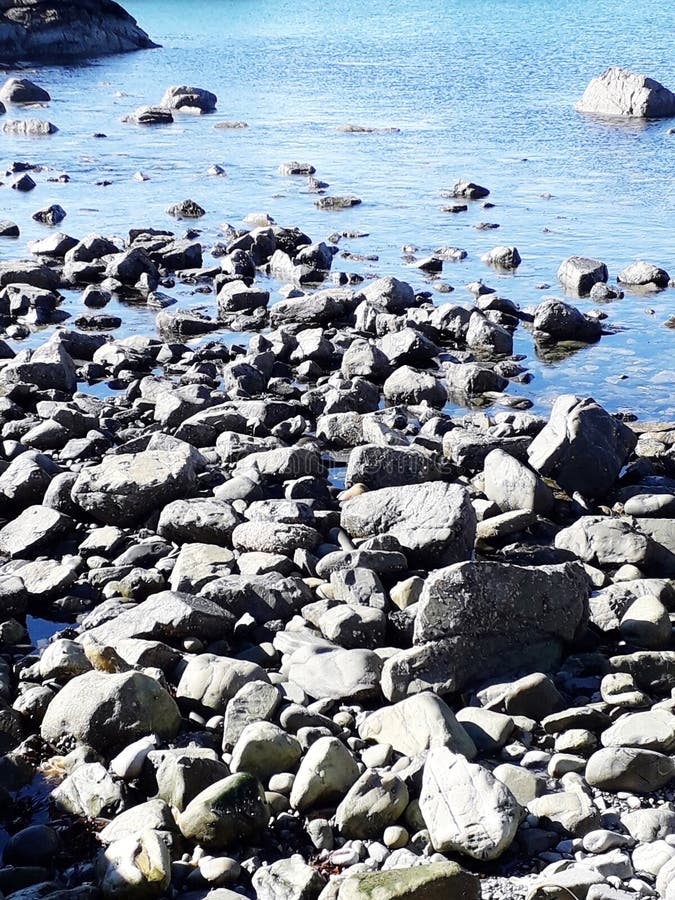 Pebble Beach and Blue Sea Against Stock Image - Image of sand, ocean ...