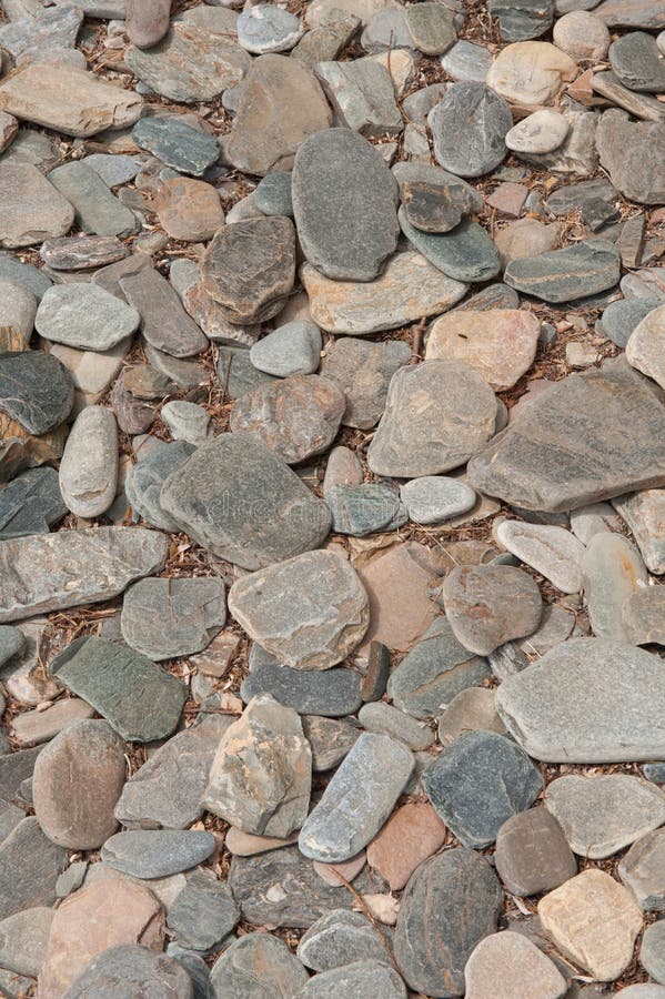 A Pebbled Beach with a Small Wave Flowing Over the Sharp Stones Stock ...
