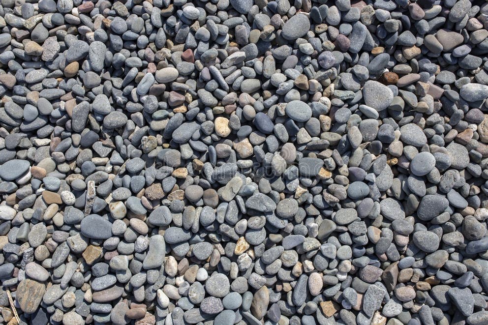 Pebbles on a Beach Background in Various Shapes, Sizes and Colours ...