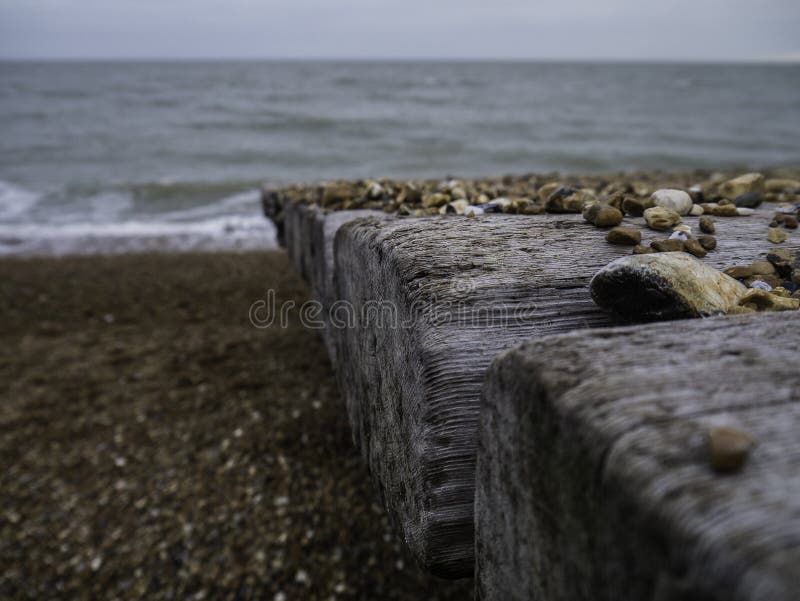 Pebbles on a Beach stock image. Image of coast, wood - 58122469
