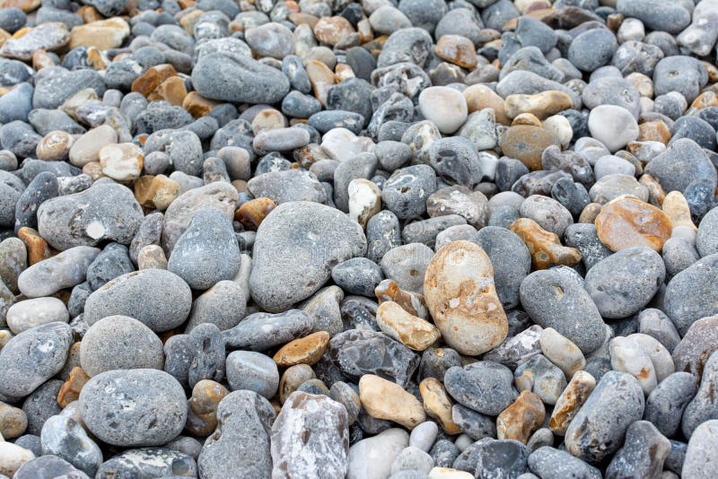 Pebbles on a beach stock photo. Image of shore, beach - 258300796