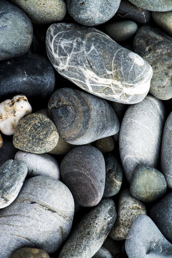 Pebbles on a rock beach stock photo. Image of scene - 127682578