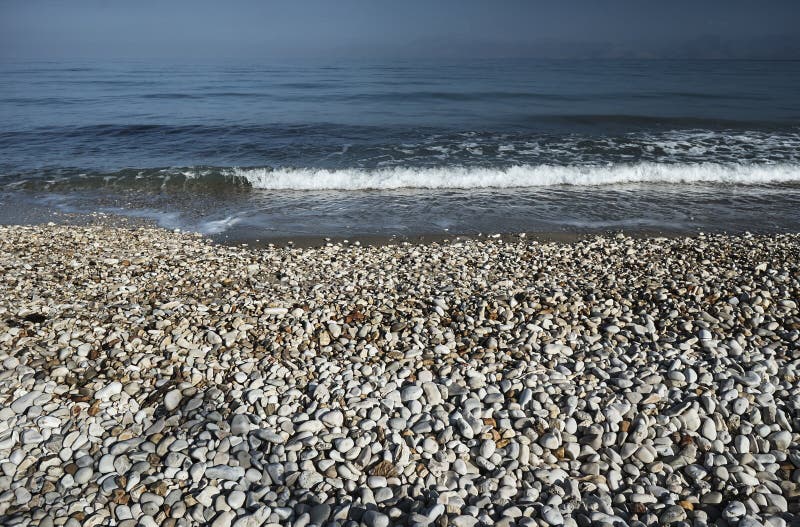 Pebbles on a sandy beach stock photo. Image of wave, beach - 98645226