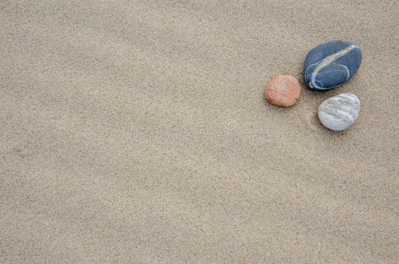Pebbles on sandy beach stock image. Image of france - 260990795