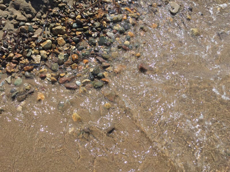 Pebbles on a sandy beach stock image. Image of rock, shore - 80843341