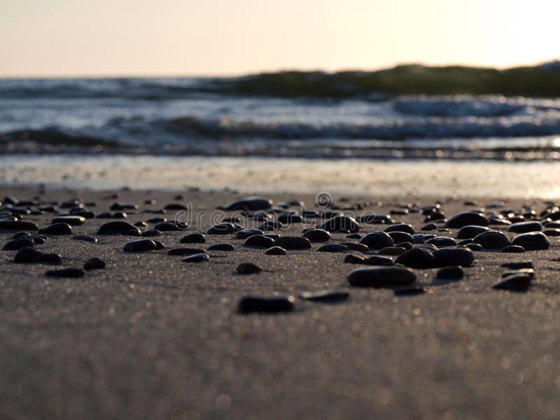 Pebbles on the sea shore stock image. Image of ripple - 25476051