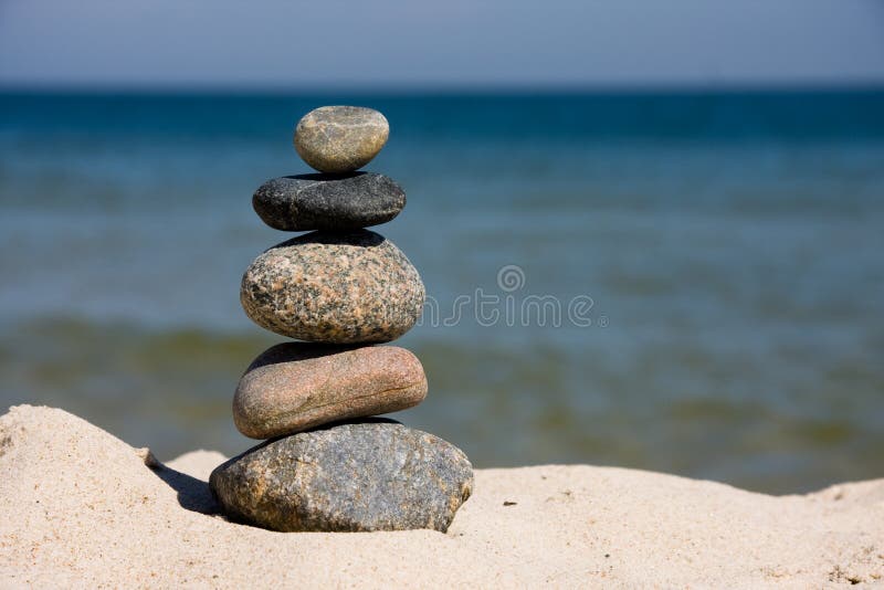 Pebbles stacked on beach stock photo. Image of stacked - 9844264