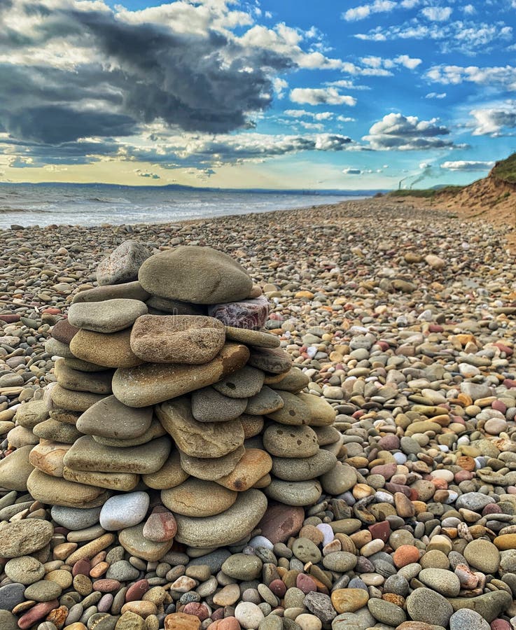 Pebbles Stacked Up on Beach in the Evening Stock Image - Image of ...