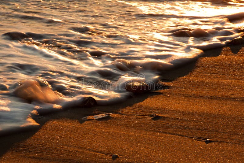 Pebbles at sunset stock image. Image of coast, light - 22808235