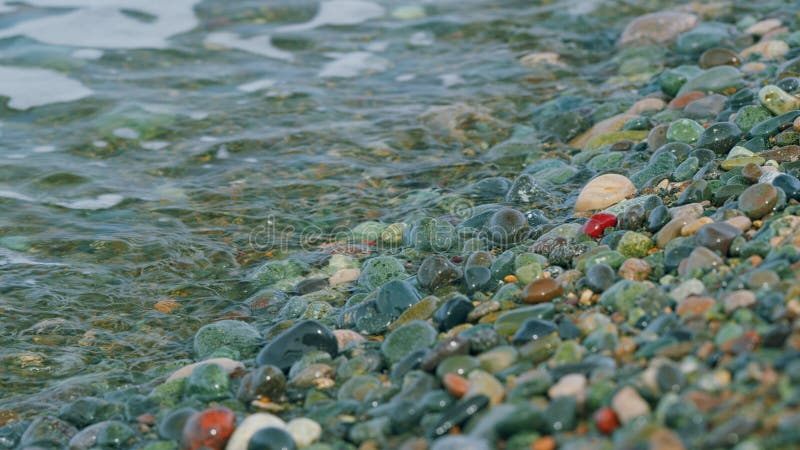 Pebbles Under the Surface of the Water. Natural Background. Waves and ...