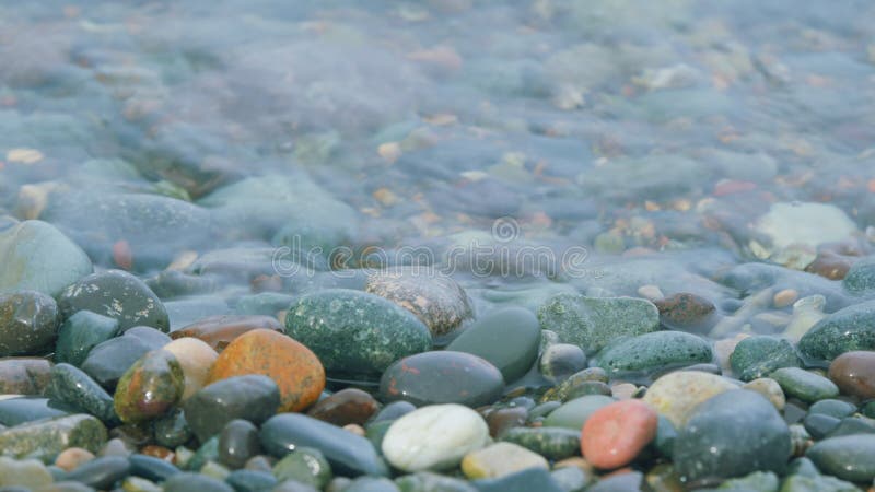 Pebbles Under the Surface of the Water. Natural Background. Waves and ...