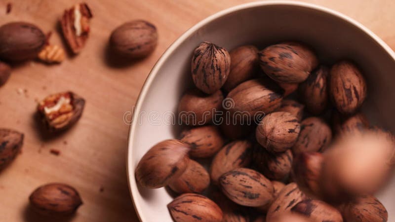 Pecan Nuts in Shell Falling into Bowl, Slow Motion., Top View. Concept ...