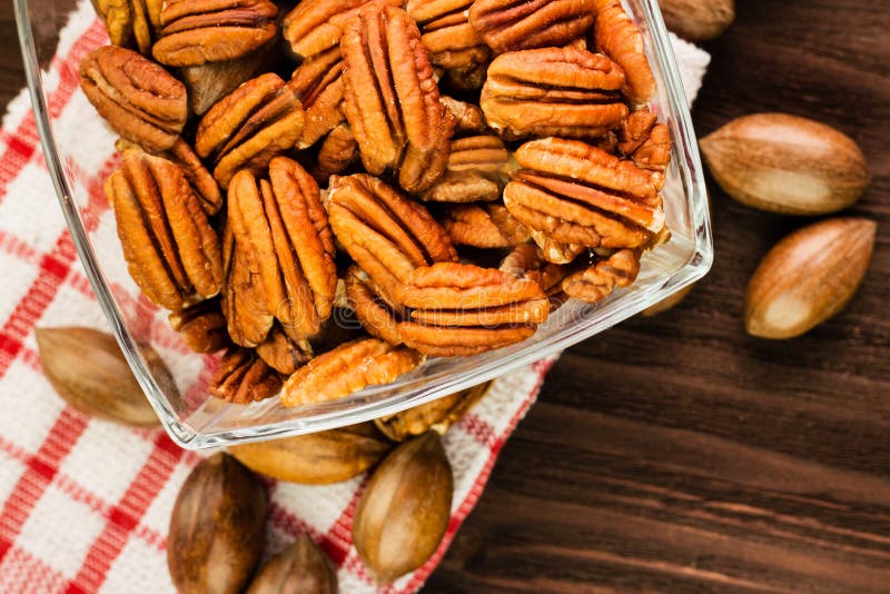 Pecan Nuts in the Shell with Pecan Kernel on Wooden Background Stock ...