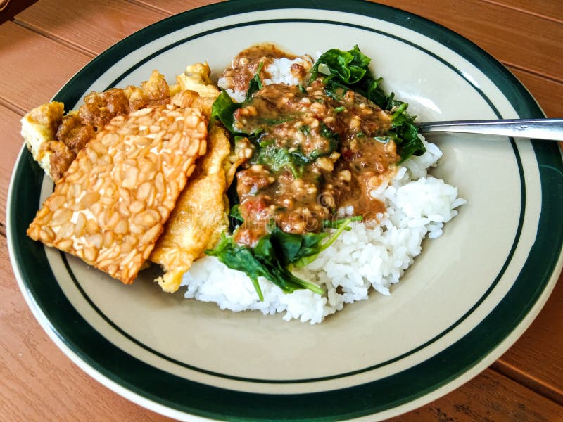 Pecel Rice with Side Dishes of Tempeh and Scrambled Eggs Stock Image ...