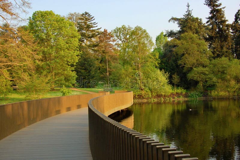 Pedestrian Bridge through the Lake in Spring Park. Stock Image - Image ...