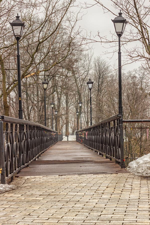 Pedestrian Bridge with Lanterns, Surrounded by Trees, Winter Stock ...
