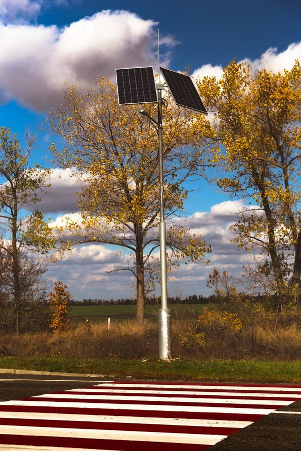 Pedestrian Crossing Lit by Roadside LED Lamps Powered by Solar Panel ...