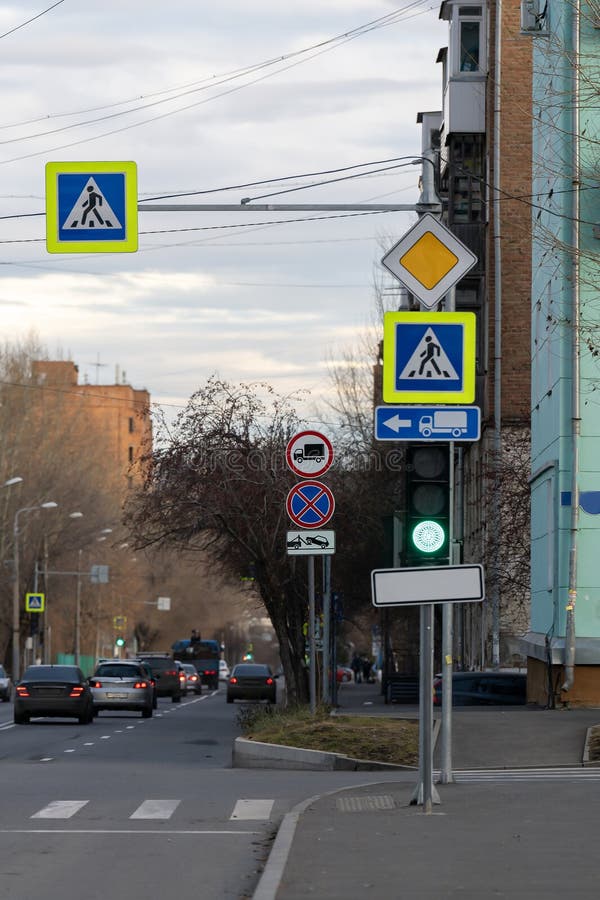 Pedestrian Crossing Signs on a Traffic Light Stand at an Intersection ...