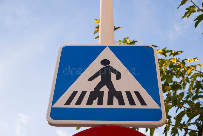Pedestrian Crosswalk Sign Against the Blue Sky with Clouds Stock Photo ...