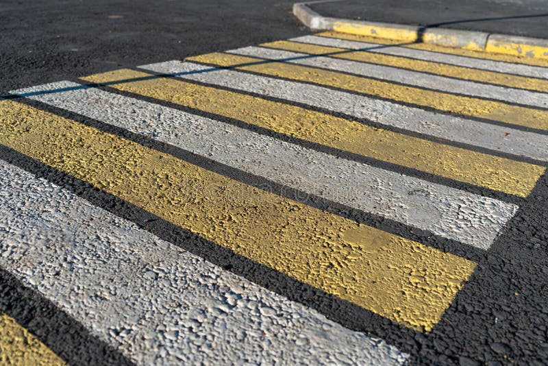 Pedestrian Crosswalk with Yellow and White Lines on the Asphalt Stock ...