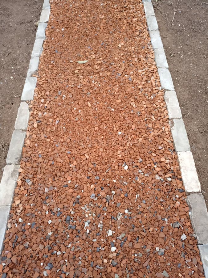 The Pedestrian Path is Lined with White Bricks and Covered with Small ...