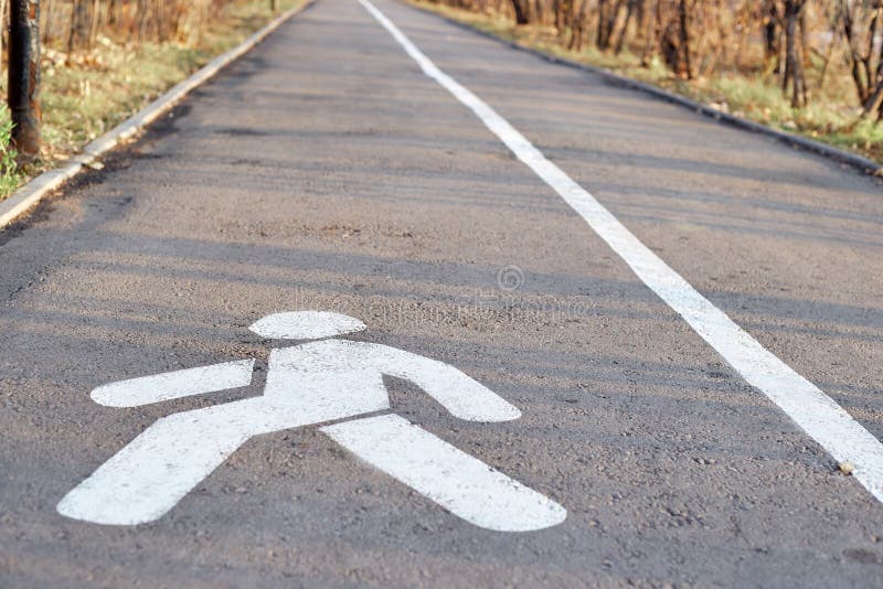 A Pedestrian Path with a Painted Sign in White Paint on the Asphalt ...