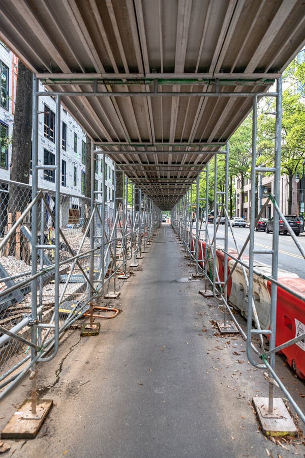 Pedestrian Path Under Scaffolding on the Side of the Road Along a ...