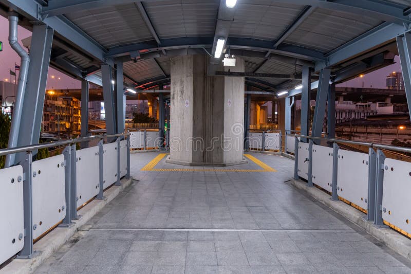 Modern Urban Pedestrian Walkway at Dusk with Minimal People and ...