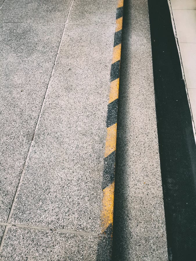 A Pedestrian Walkway with Yellow Edges Contrasting with a Black Layer ...