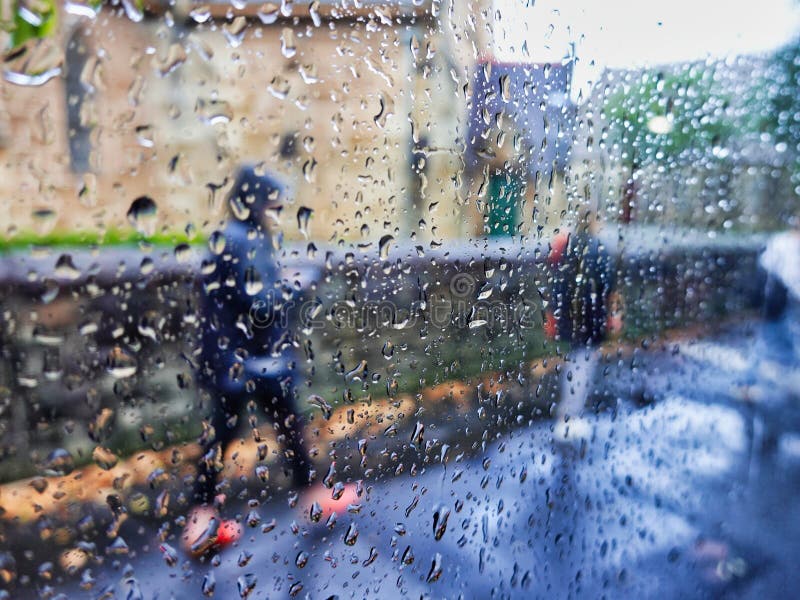 Pedestrians in Heavy Rain, View through Raindrops on Window Stock Photo ...