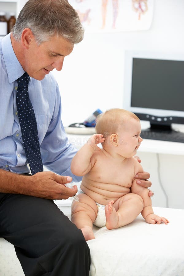 Pediatrician with baby stock photo. Image of exam, fifties - 19905596