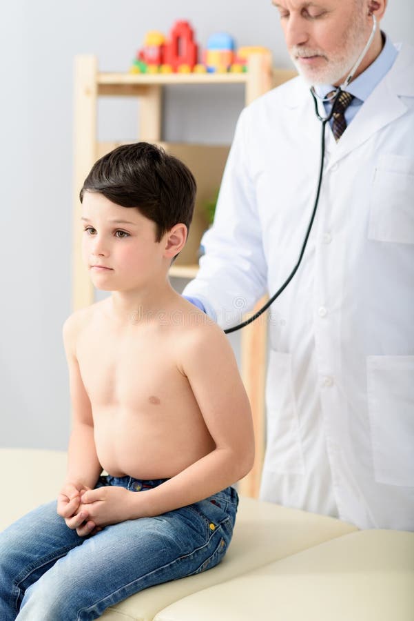 Pediatrician Doing Checkup on Young Boy Stock Photo - Image of patient ...