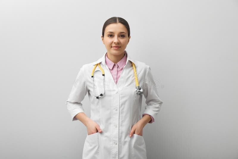 Pediatrician in Uniform with Stethoscope on Grey Background Stock Image ...
