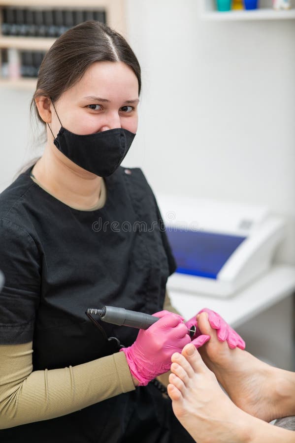 The Pedicure Master Processes the Client S Foot Using an Apparatus with ...