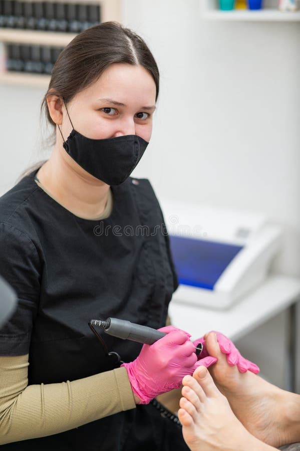 The Pedicure Master Processes the Client S Foot Using an Apparatus with ...