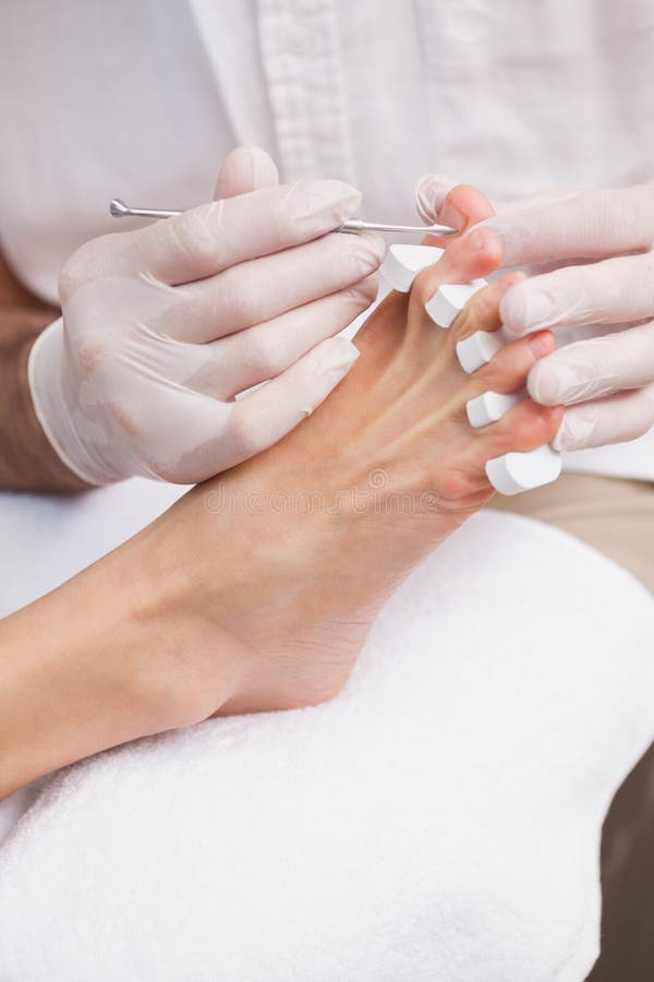 Pedicurist Cleaning a Customers Toe Nails Stock Image - Image of ...