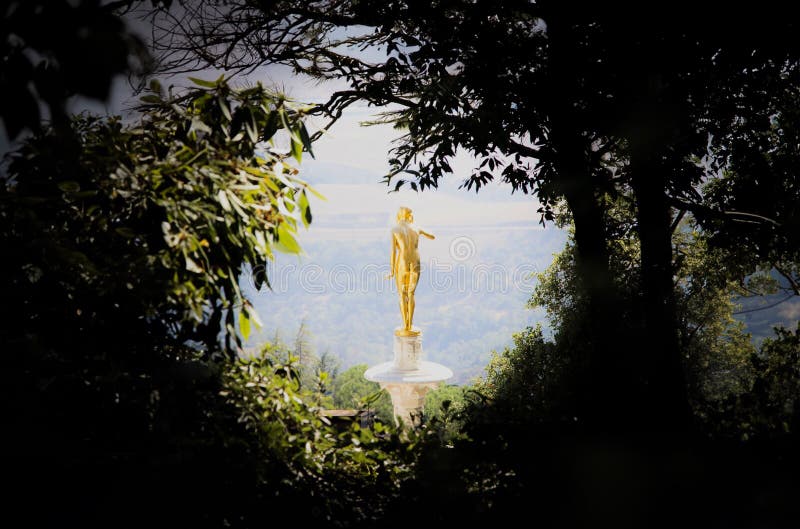 Golden Statue through the Trees Stock Photo - Image of girl, culture ...