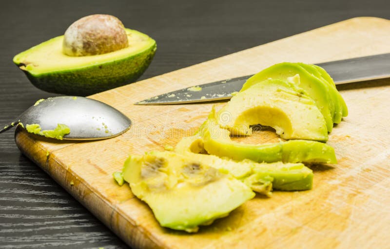 Avocado Cut into Strips on a Chopping Board. Stock Photo - Image of ...