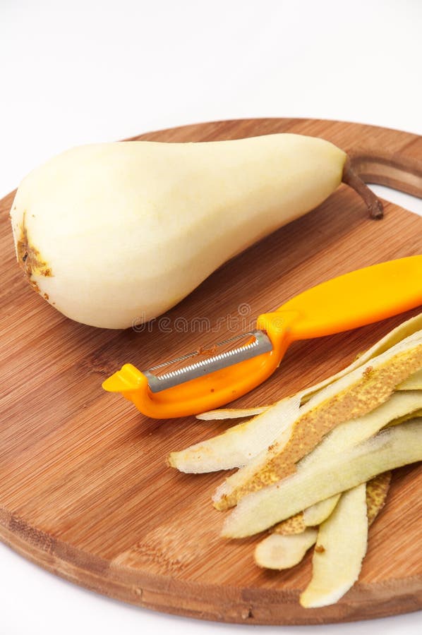 Peeled Pear with a Tool for Peeling on Wooden Board Stock Photo - Image ...