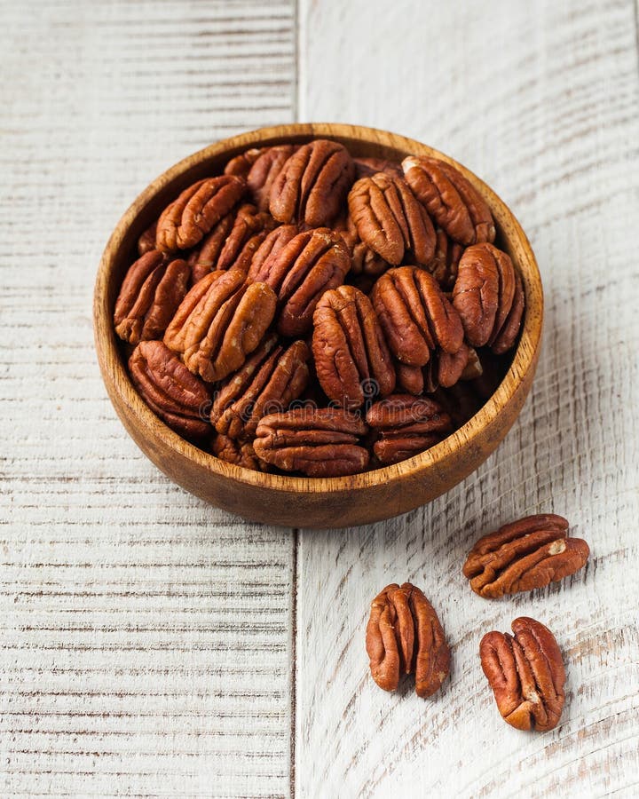 Peeled Pecans in a Wooden Bowl on a White Wooden Background. Nuts ...