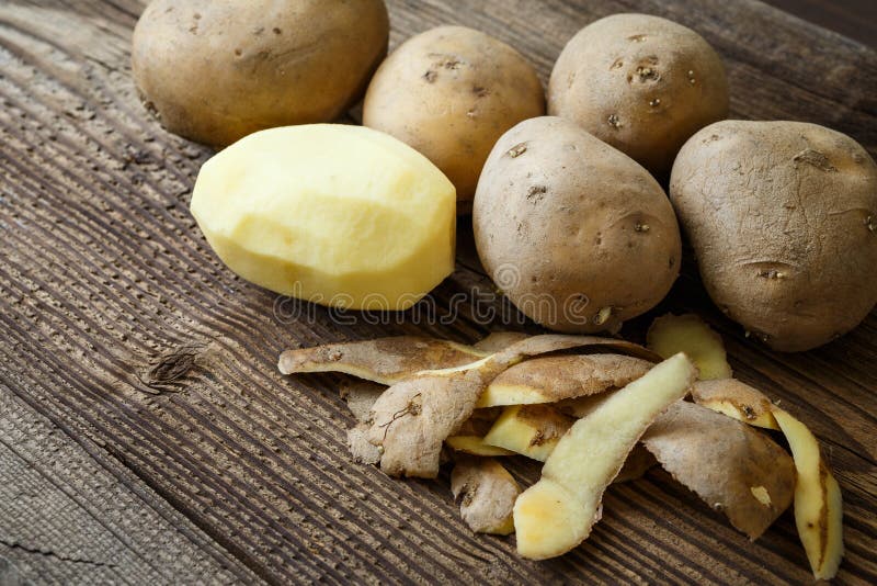 Peeled Potato and Pile of Potatoes Stock Image - Image of peeled ...