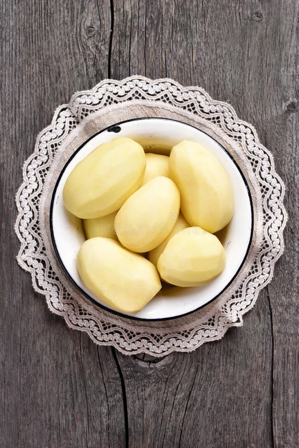 Peeled potatoes in bowl stock image. Image of healthy - 63250769