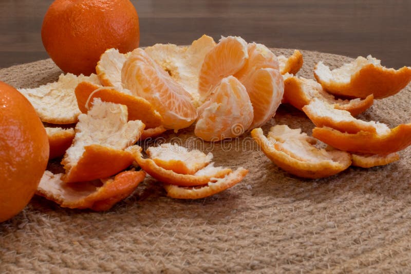 Peeled Ripe Tangerine in Peel Close-up on Dining Table Stock Photo ...