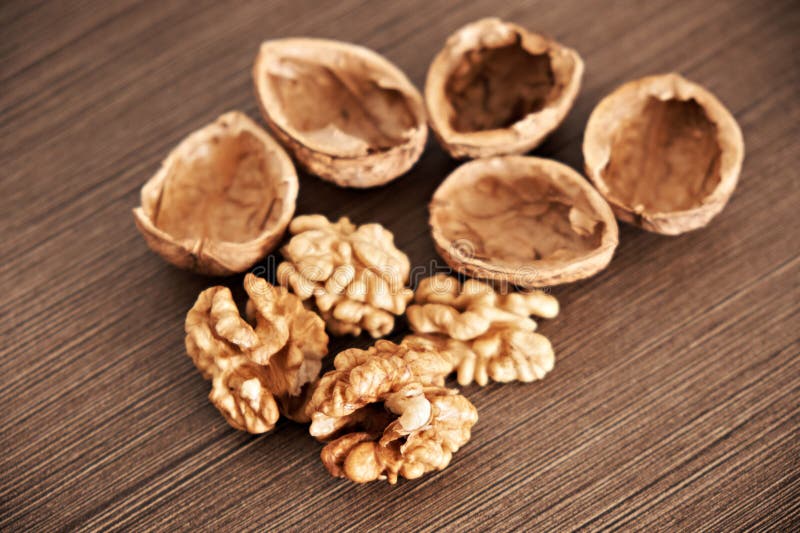 Peeled Walnut Kernels and Their Shells on a Dark Table. Healthy Eating ...